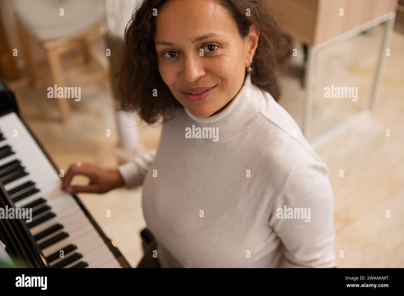 Authentic portrait charming female musician pianist looking at camera ...