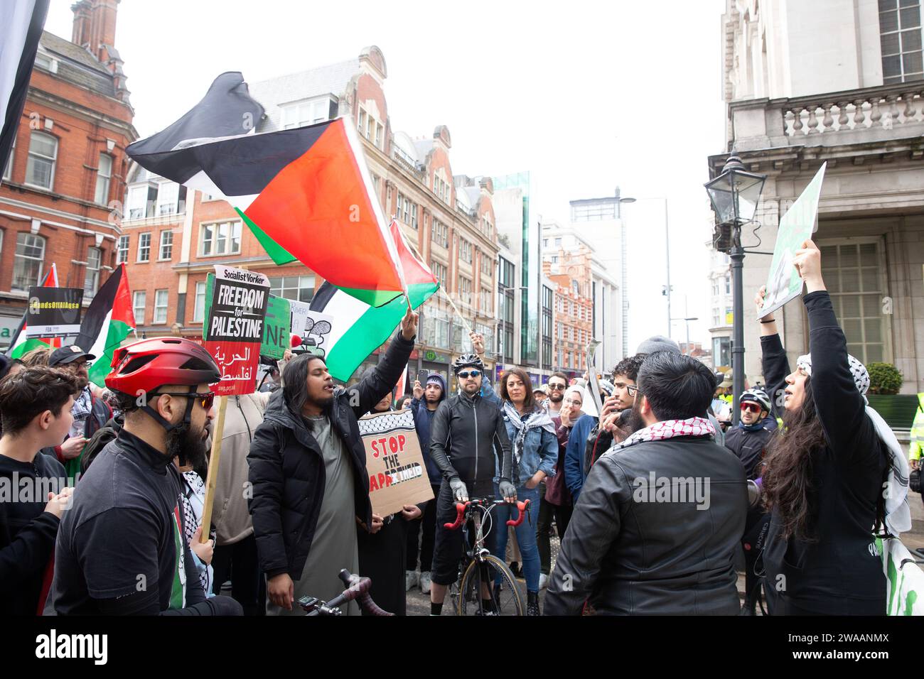 Pro-Palestinian protesters gather with flags and placards during a ...