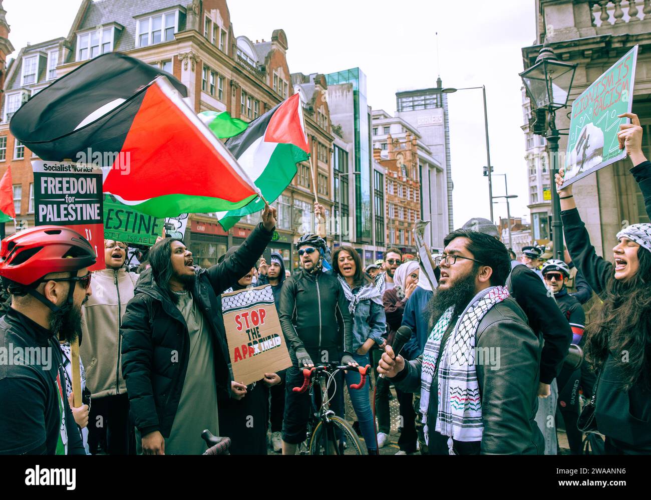Pro-Palestinian protesters gather with flags and placards during a ...