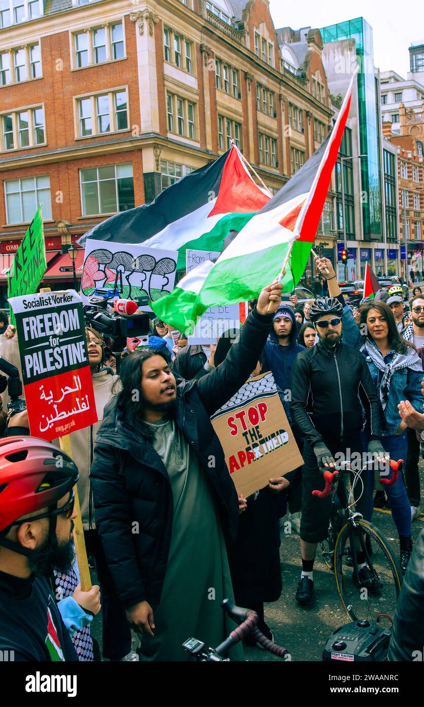 Pro-Palestinian protesters gather with flags and placards during a ...