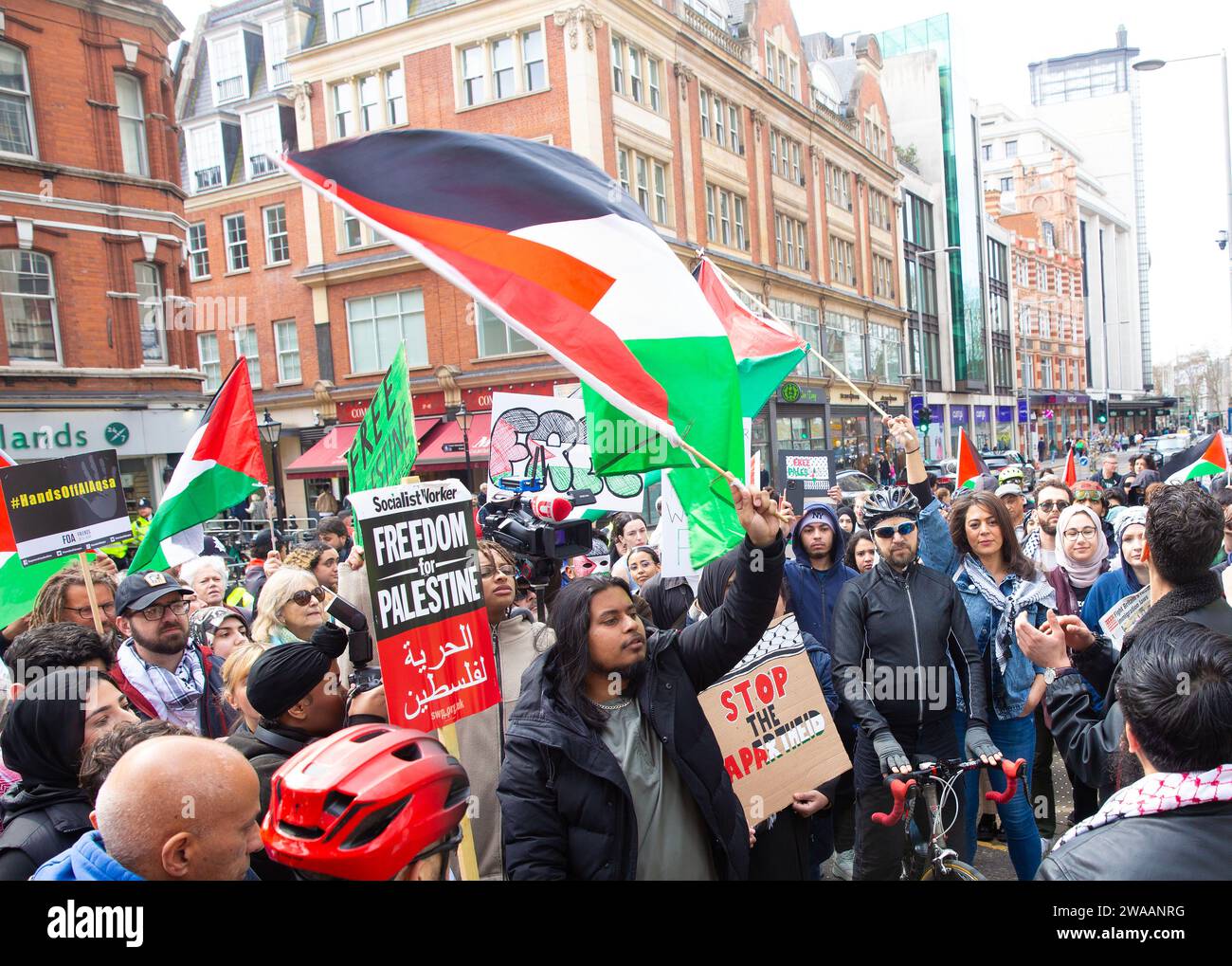 Pro-Palestinian protesters gather with flags and placards during a ...