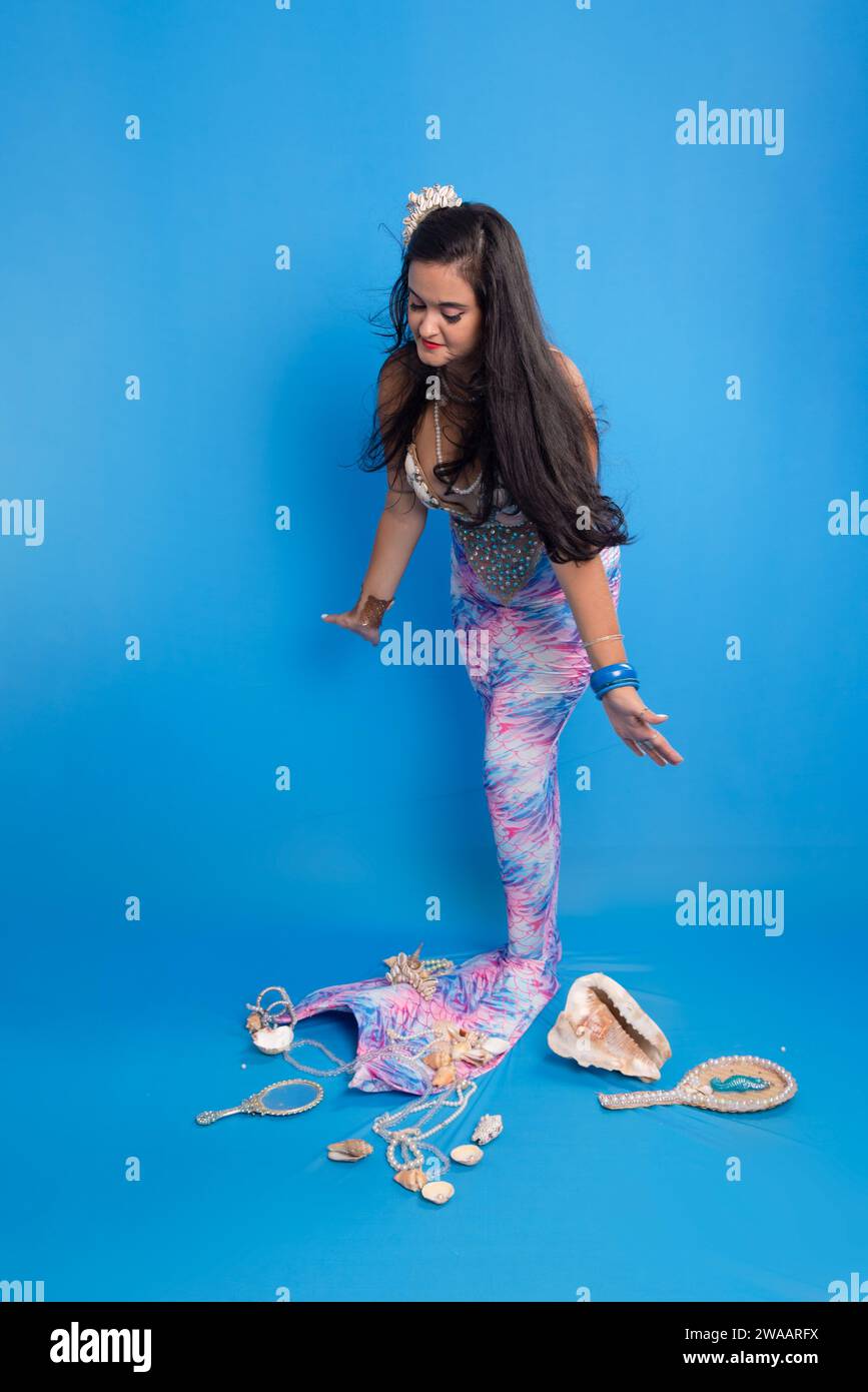 Beautiful woman, with black hair, wearing a tiara and bracelets made of ...