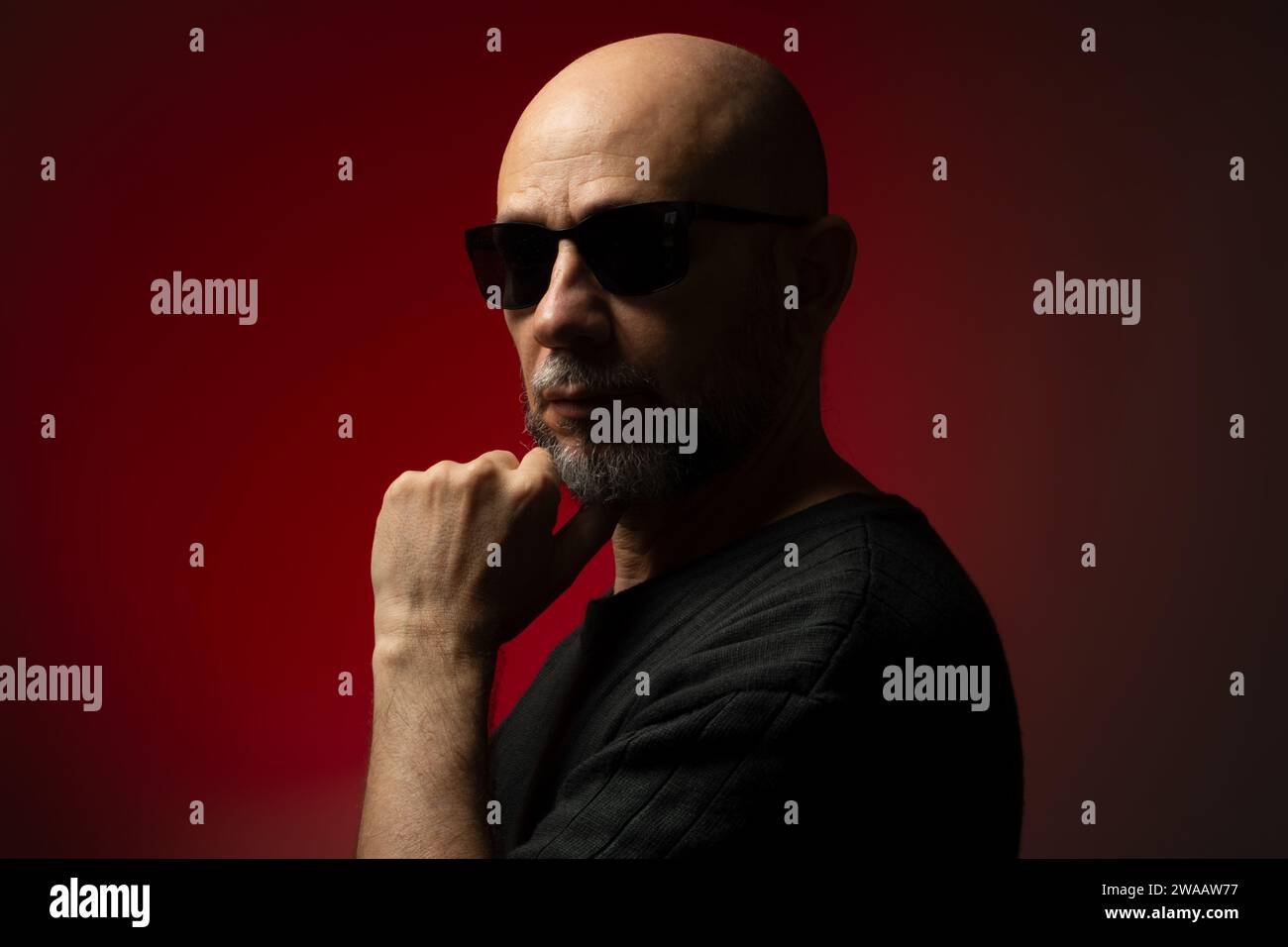 Handsome, bald and bearded man in sunglasses, serious and confident ...
