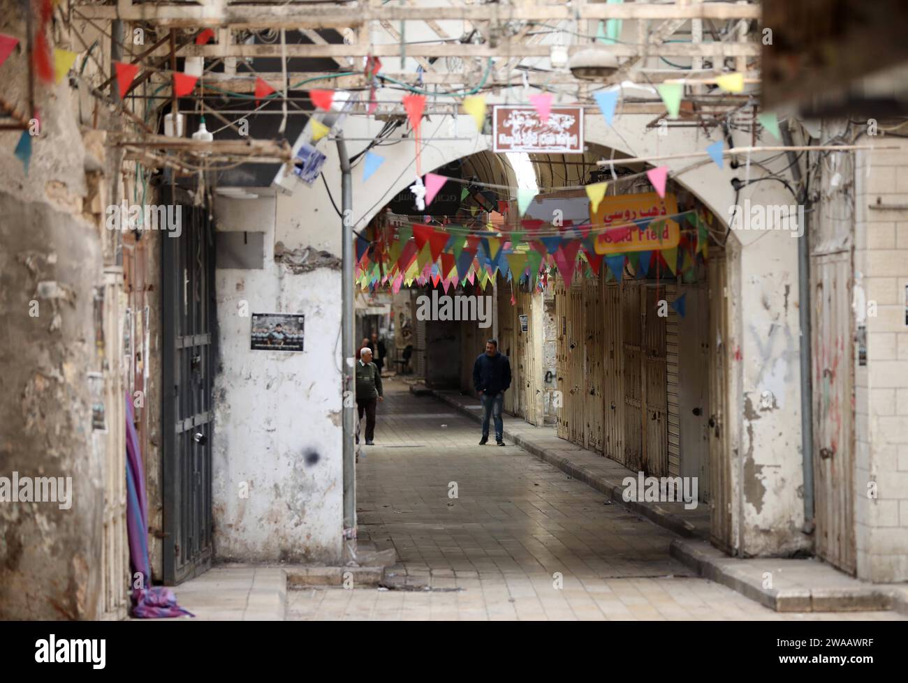 People walk past closed shops during a general strike in the bazaar of ...