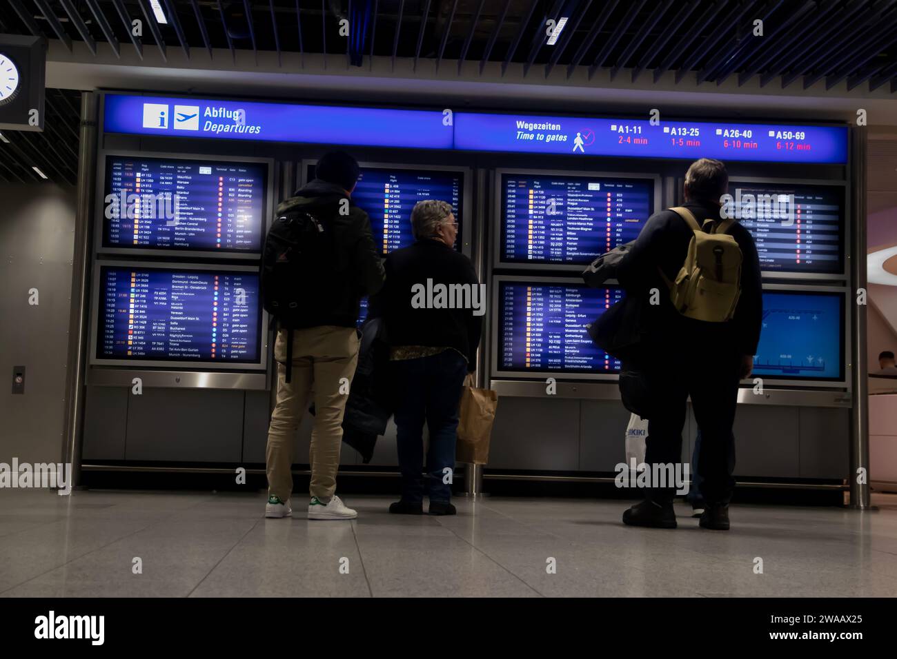 Late night crowd of people a front of information board at the airport ...