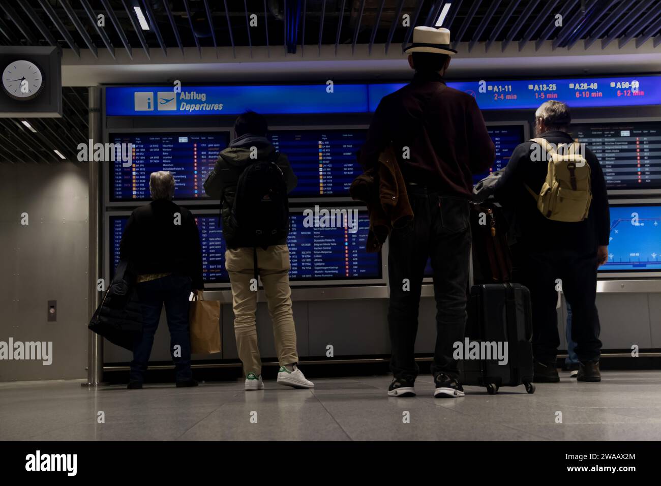 Late night crowd of people a front of information board at the airport ...