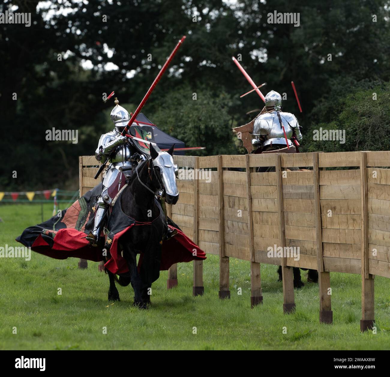 Kenilworth England 07 29 2023 Two Knights jousting hitting lances on impact the lance shatters ...