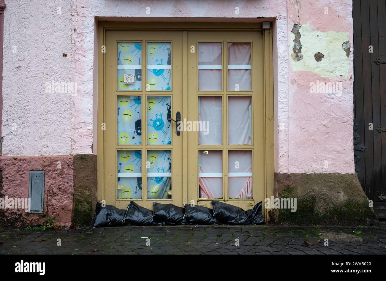 Ottweiler, Germany. 03rd Jan, 2024. Sandbags lie in front of a door in ...