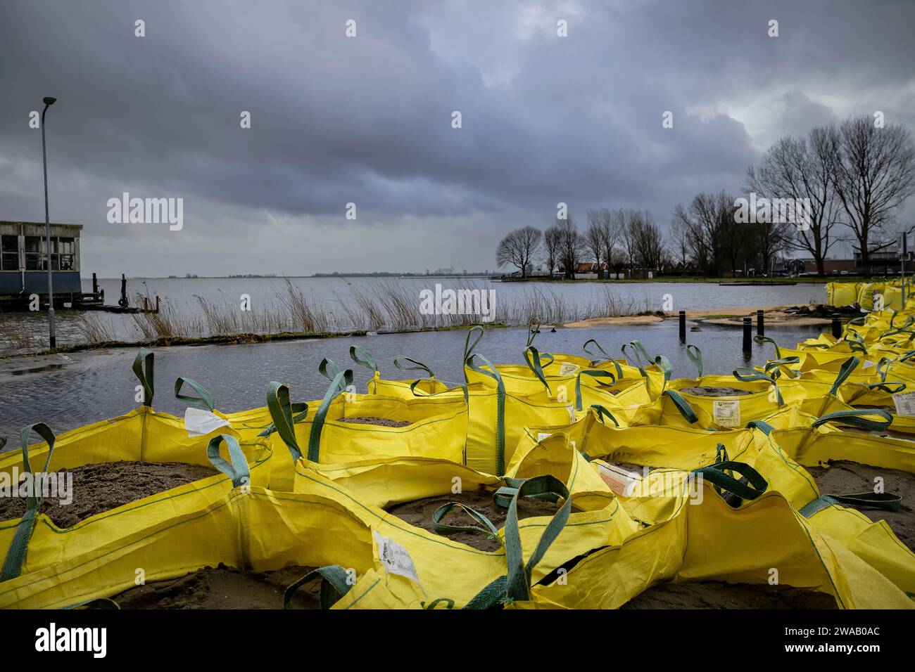 Volendam, Netherlands. 3 January, 2023. Sandbags in a flooded street ...