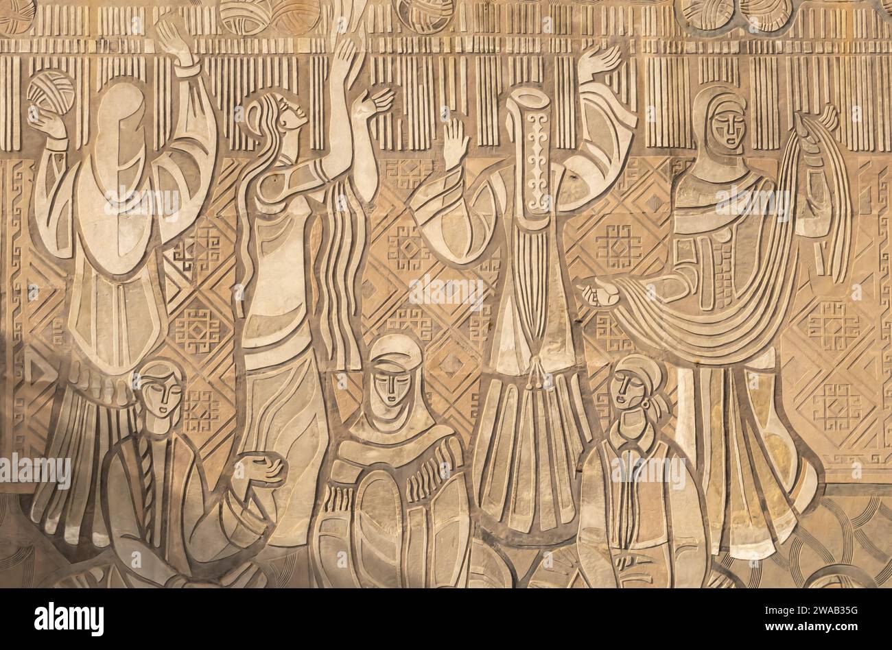 Sgraffiti mural depicting kazakh women manufacturing weaving carpets on ...