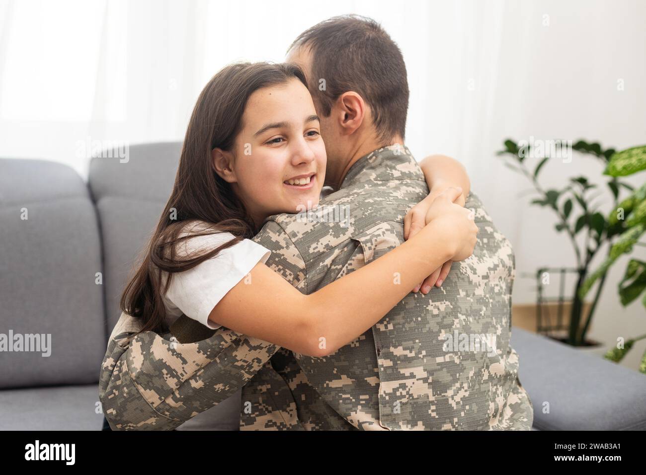 pretty little girl hugging her military father Stock Photo - Alamy