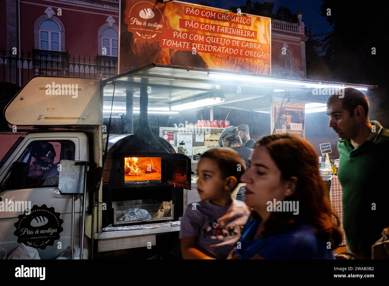 Lisbon, Portugal - 27 August 2022 : Small lit oven on a chorizo bread ...