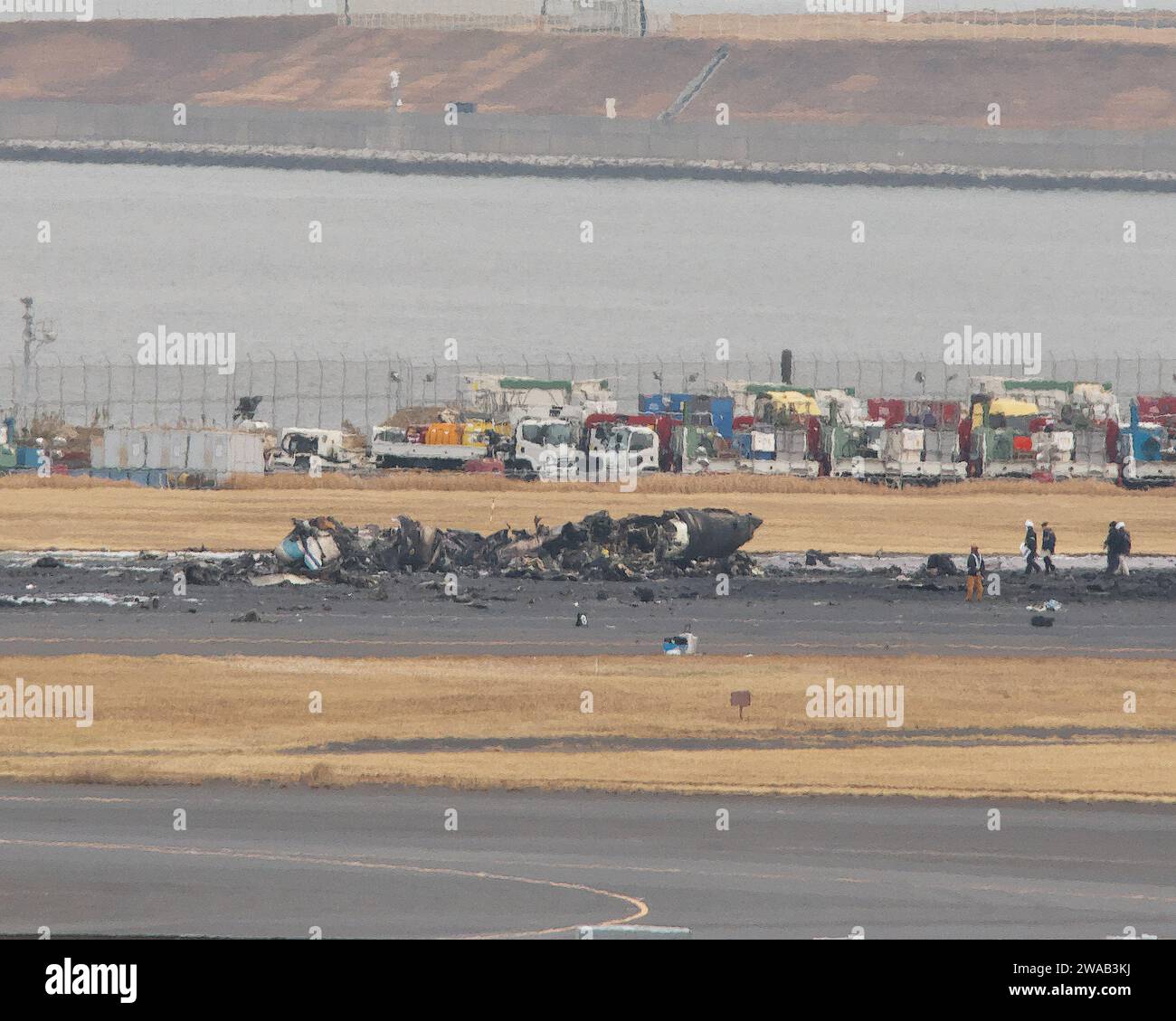 Tokyo, Japan. 03rd Jan, 2024. Officials investigate a burnt Japan coast ...