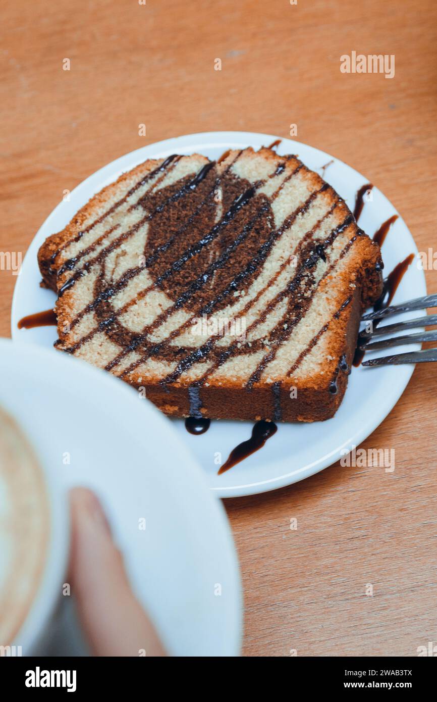 vertical image unrecognizable woman with portion of marbled pudding on ...