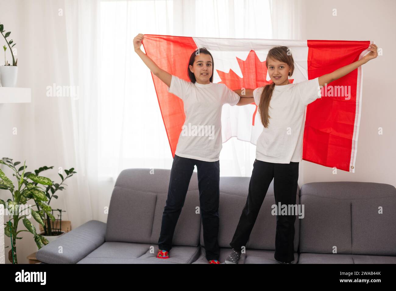 Happy Canada Day Celebration. Two girls with big Canada flag in their ...