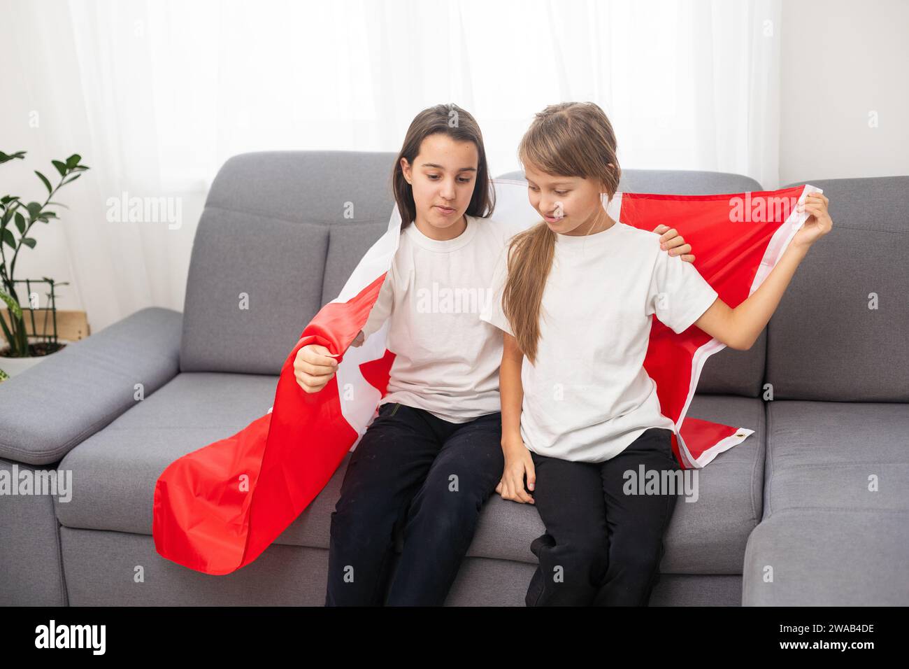 Happy Canada Day Celebration. Two girls with big Canada flag in their ...