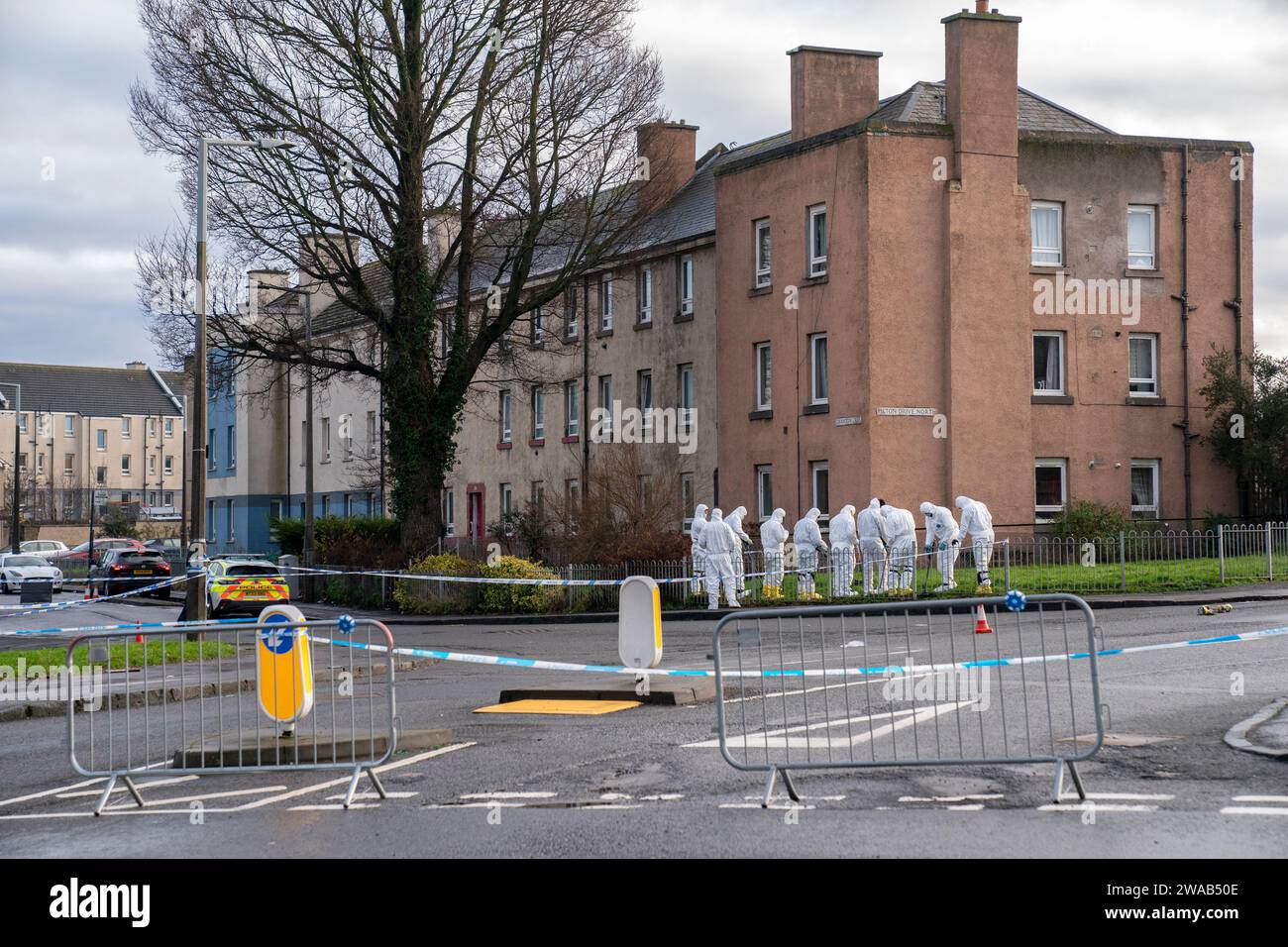 Police forensic officers search the area close to the scene near the ...