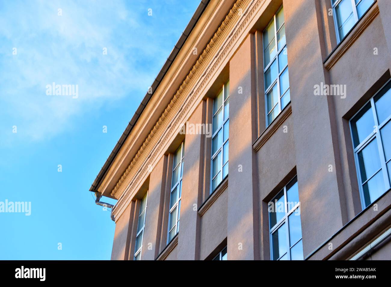 The facade of a classic building in the city. The windows of the ...