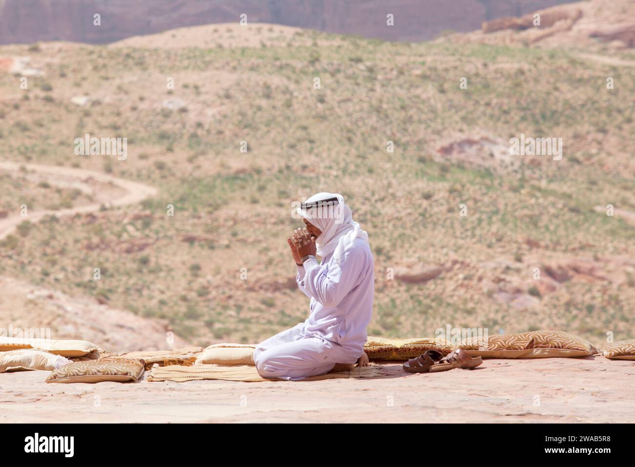 A Muslim praying inside the archaeological site of Petra, Jordan Stock ...
