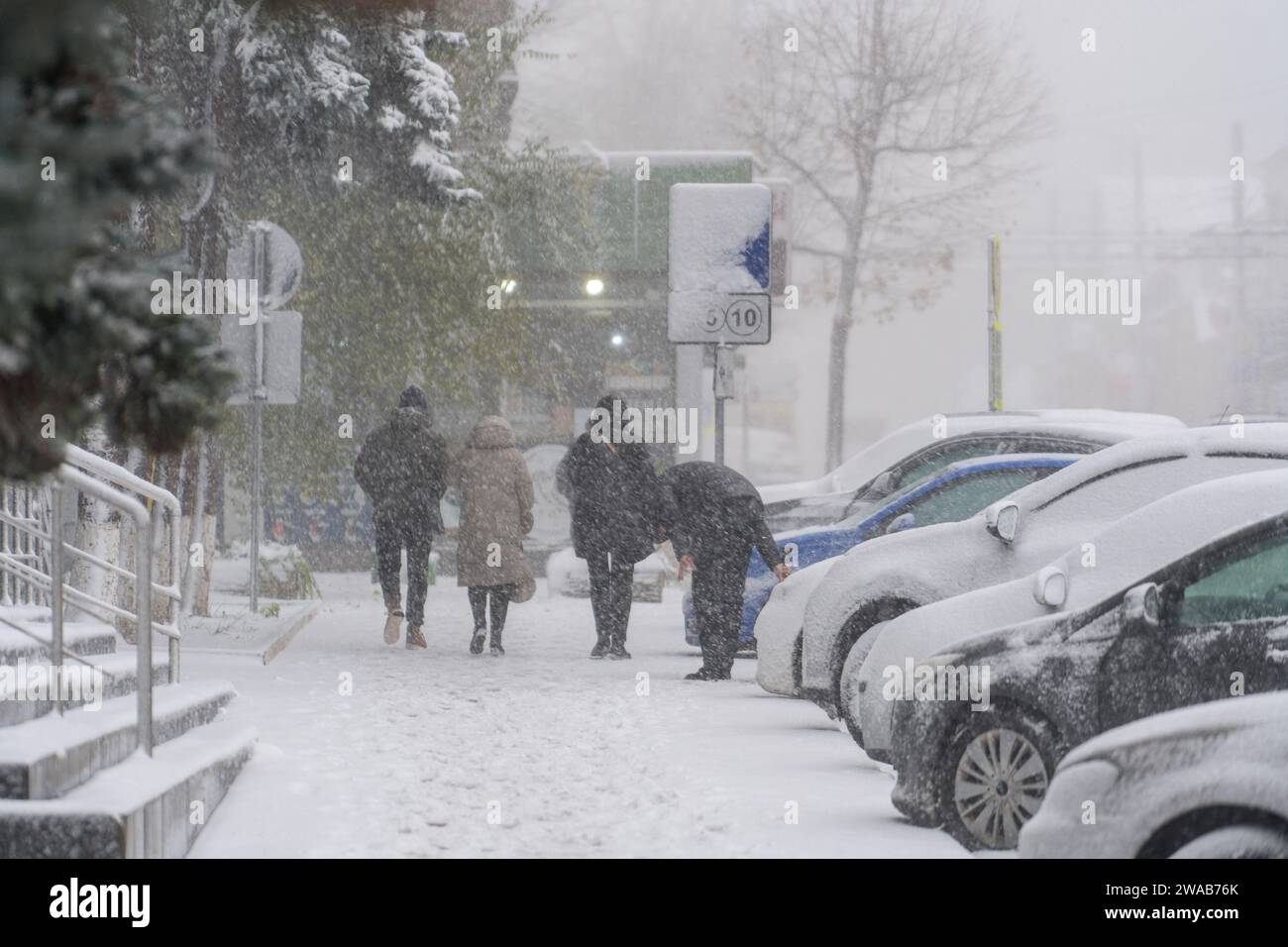 Group of people walking in the snow storm on the city streets Stock ...