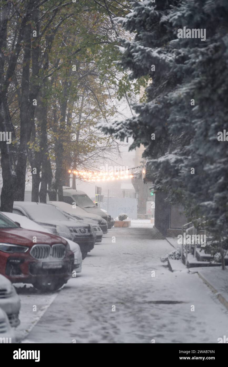 Snow-covered parked cars on a city street in winter Stock Photo - Alamy