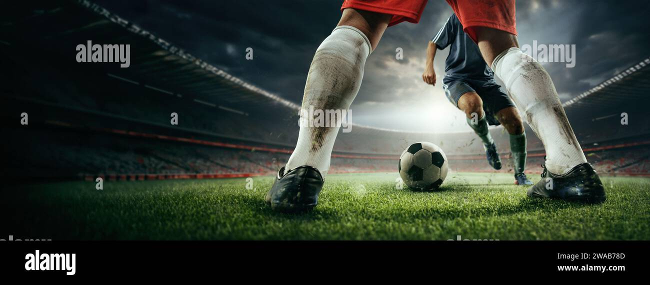 Cropped image of male legs in dirty uniform, football players during ...