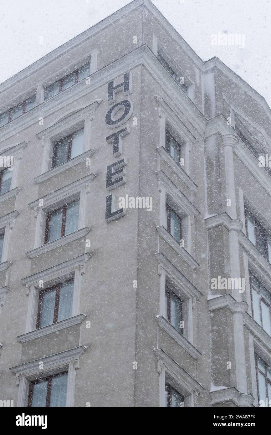 Snowflakes falling on city hotel facade Stock Photo - Alamy