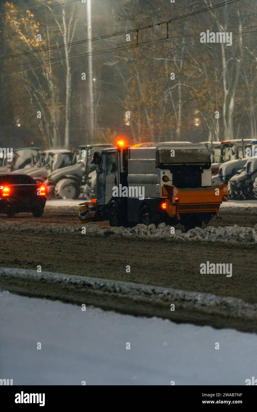 Snow removal machines operating on snowy city streets Stock Photo - Alamy