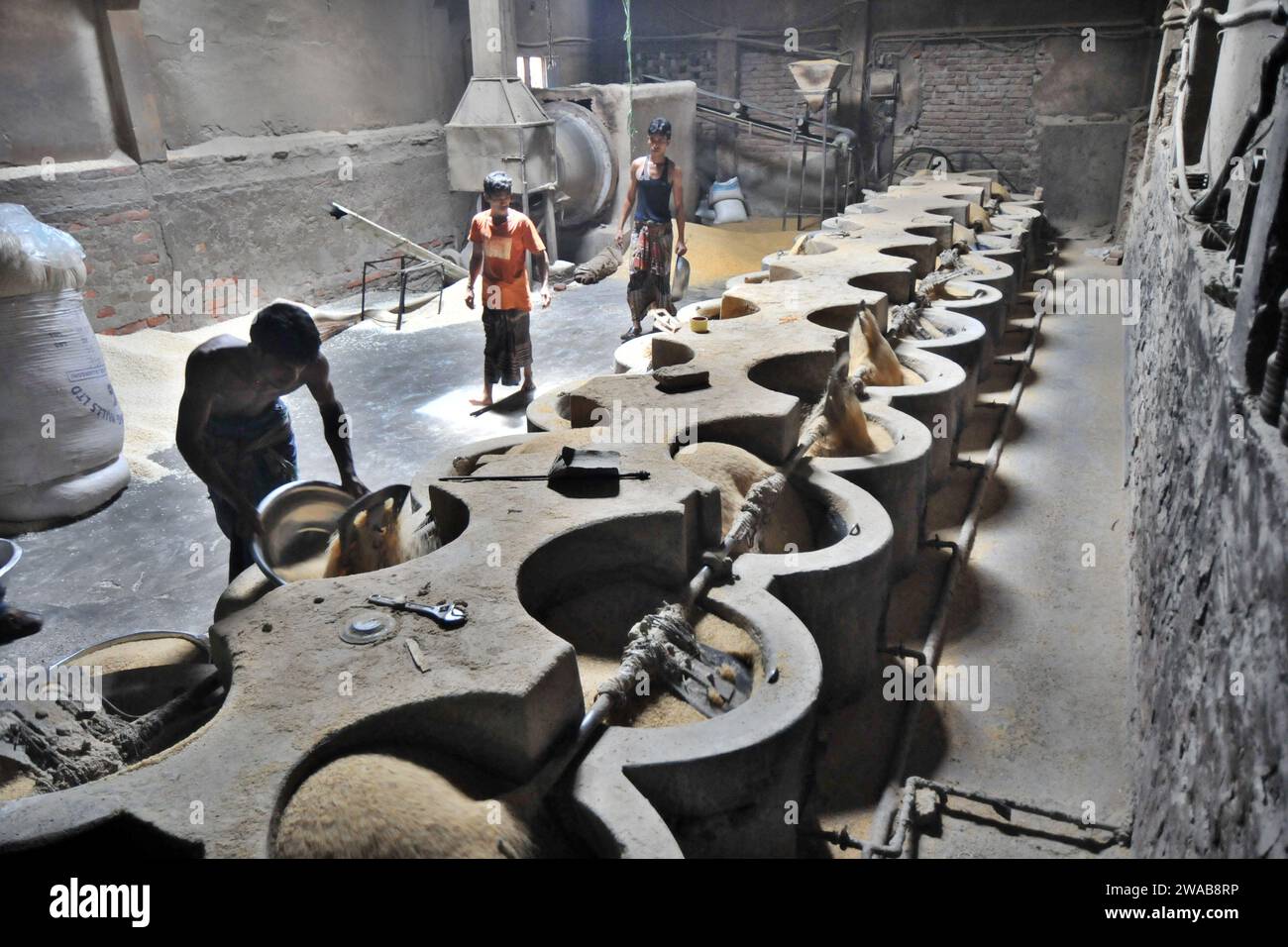 Bangladeshi worker works in a puffed rice factory in Dhaka City in ...
