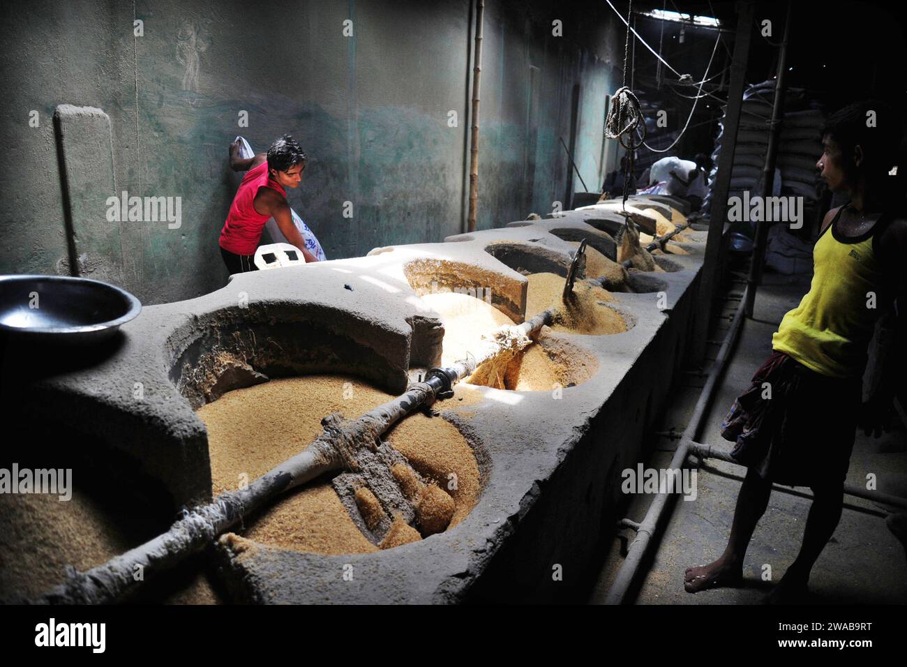 Bangladeshi worker works in a puffed rice factory in Dhaka City in ...