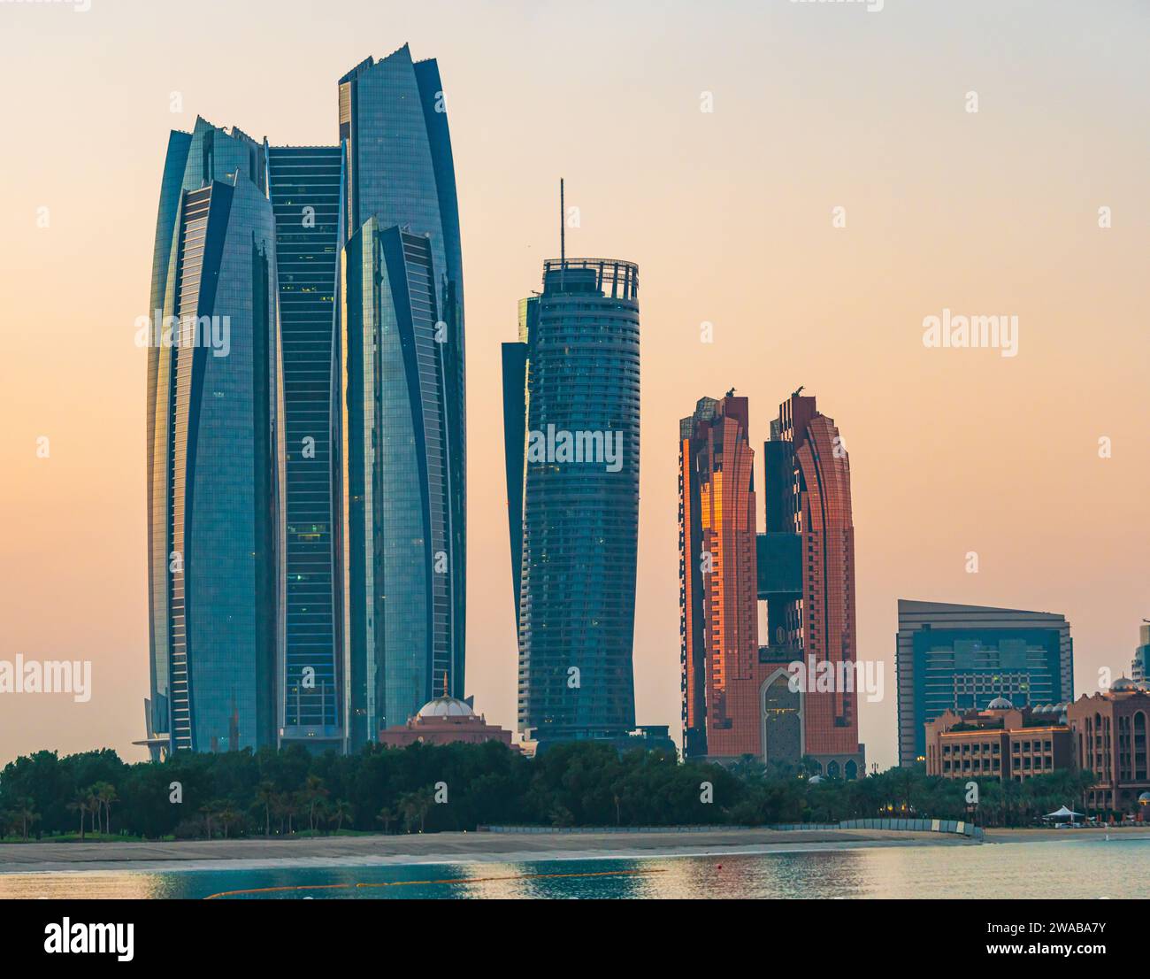 Abu dhabi, the Etihad towers at sunrise, orange sky, modern skyscrapers ...