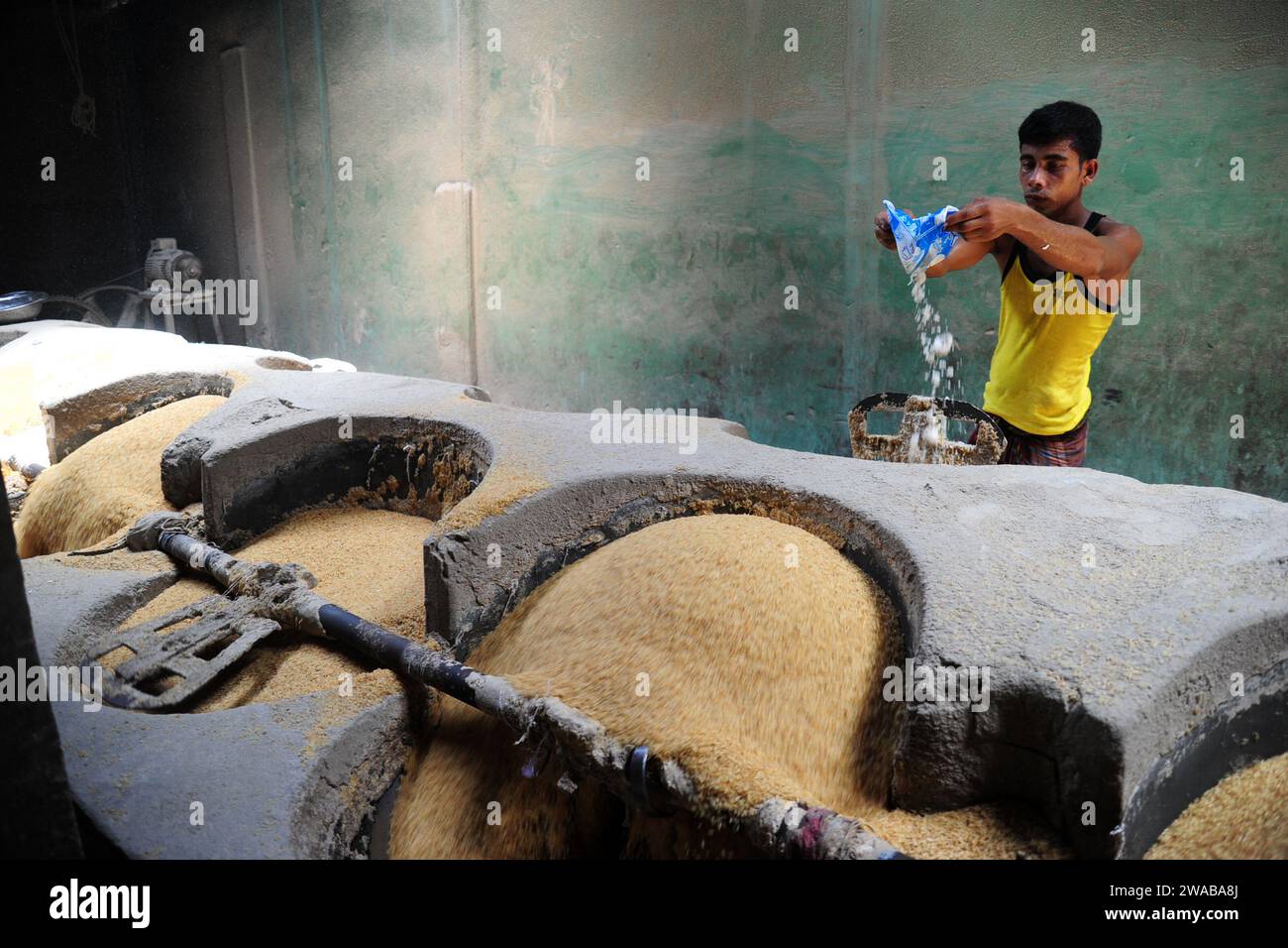 Bangladeshi worker works in a puffed rice factory in Dhaka City in ...
