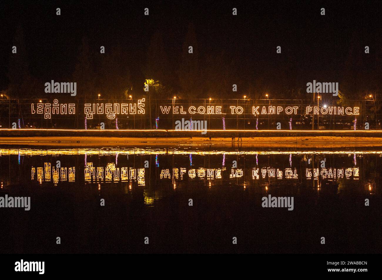 Bilingual "Welcome to Kampot Province" sign lit up at night on The ...