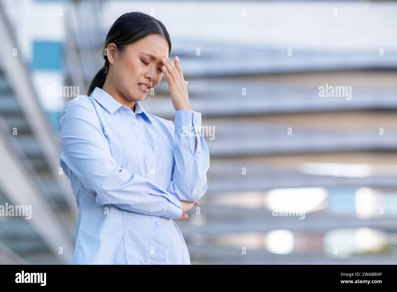 Korean businesswoman crying upset suffering from stress and headache ...