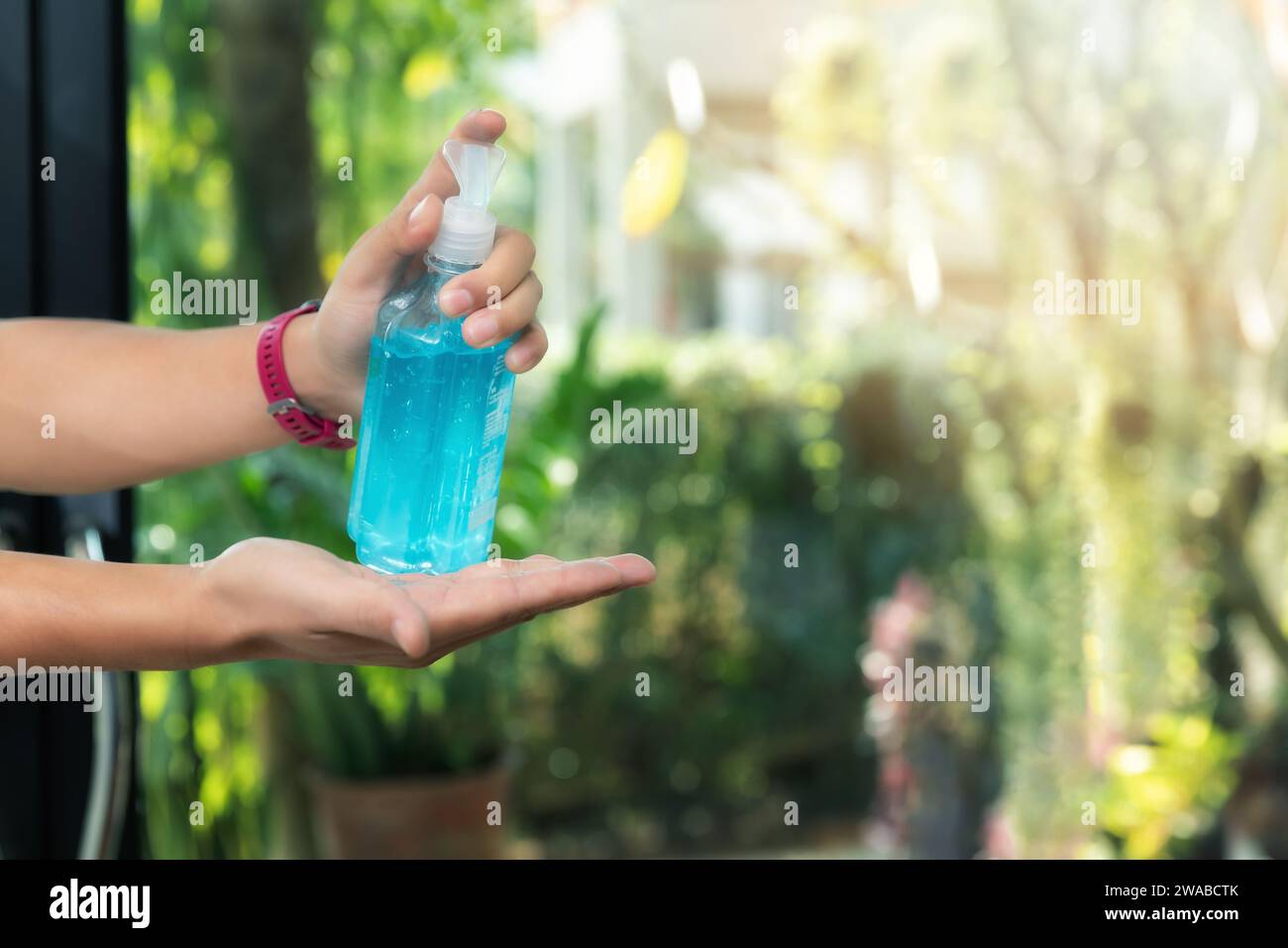 A man using alcohol based hand sanitizer for cleaning hands before ...