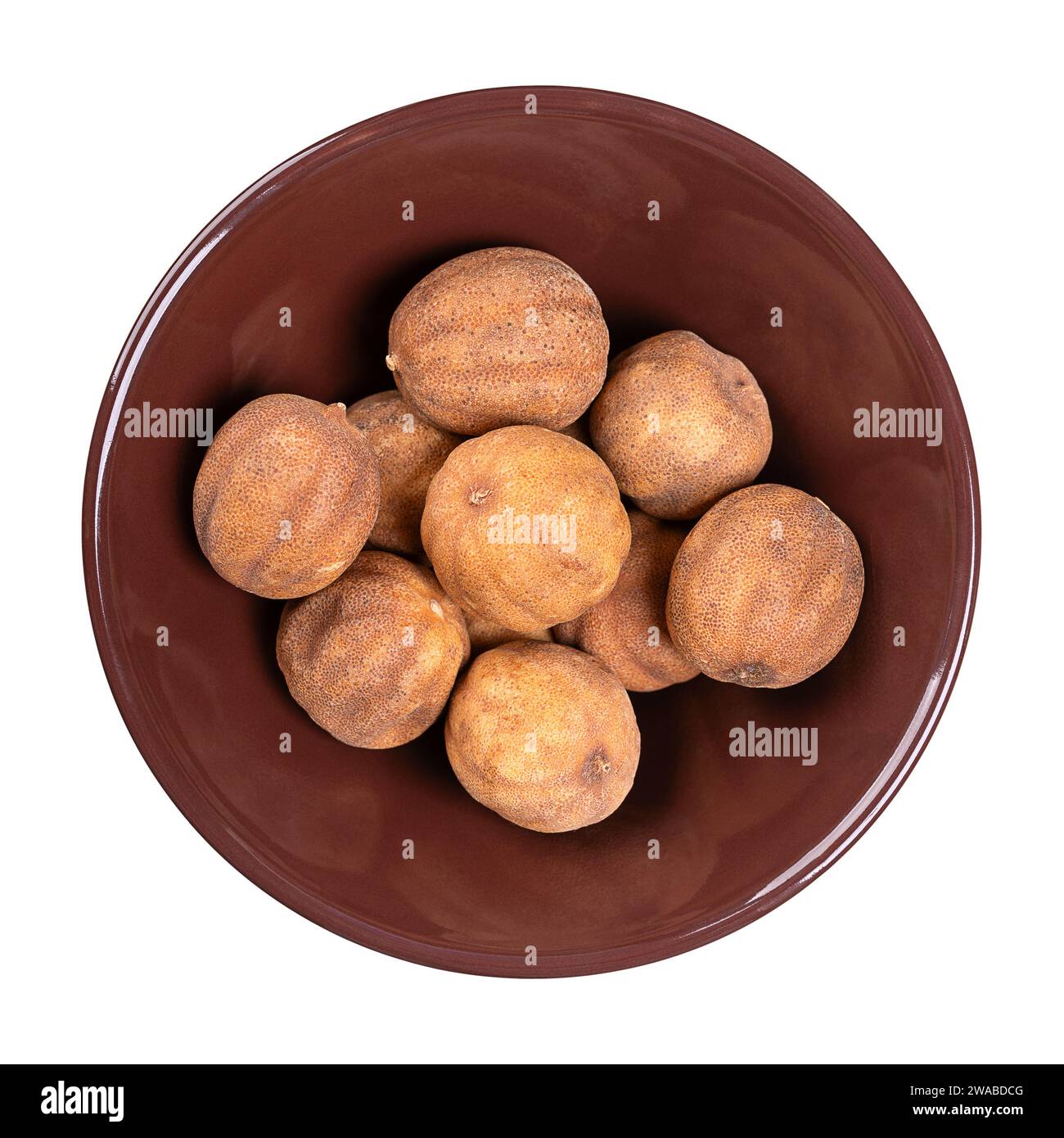 Whole dried limes, in a brown ceramic bowl. Also loomi, black lime ...