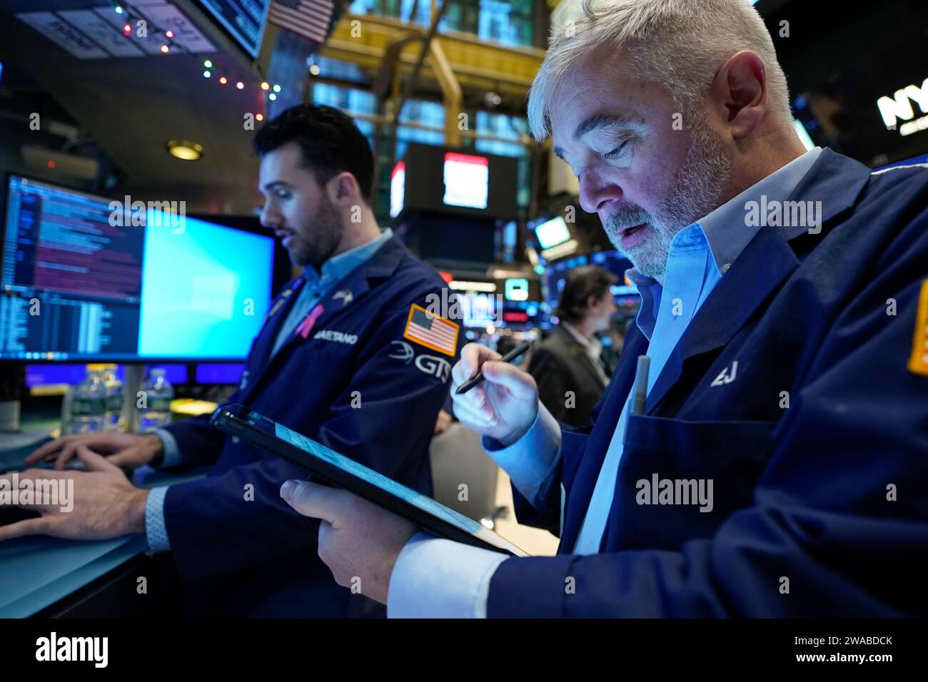 Traders work on the floor at the New York Stock Exchange in New York ...