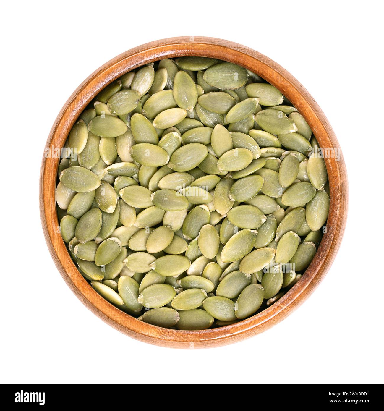 Pepitas, hulled pumpkin seeds, in a wooden bowl. Edible pumpkin seeds ...