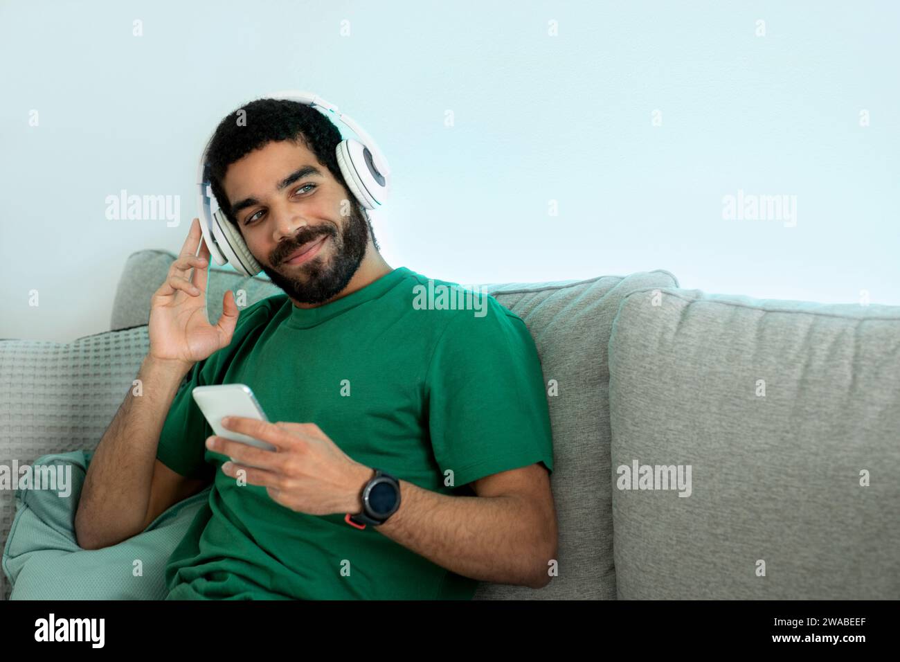 Relaxed man lounging on sofa hi-res stock photography and images - Alamy