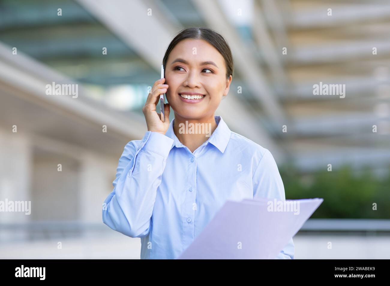 Japanese female using smartphone making hi-res stock photography and ...