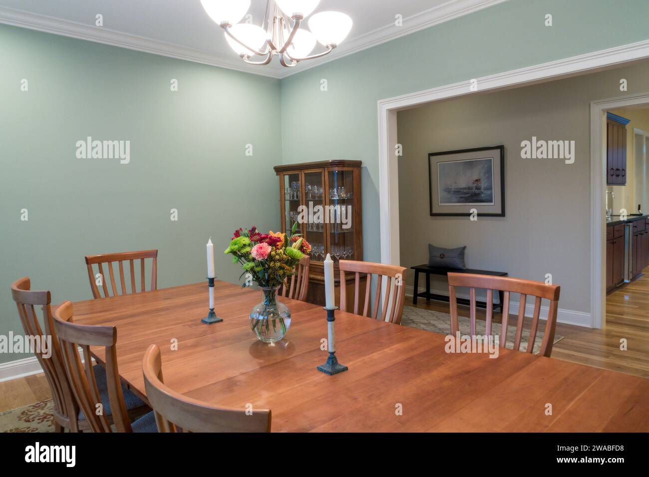 Large suburban dining room features a wooden table with seating for ...