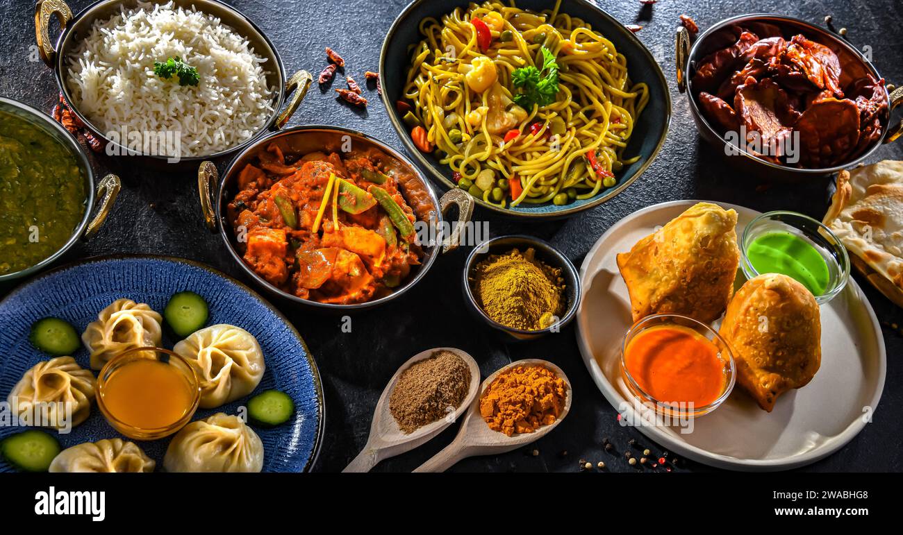 Composition with indian dishes: samosa, pakora, palak paneer, jalfrezi ...