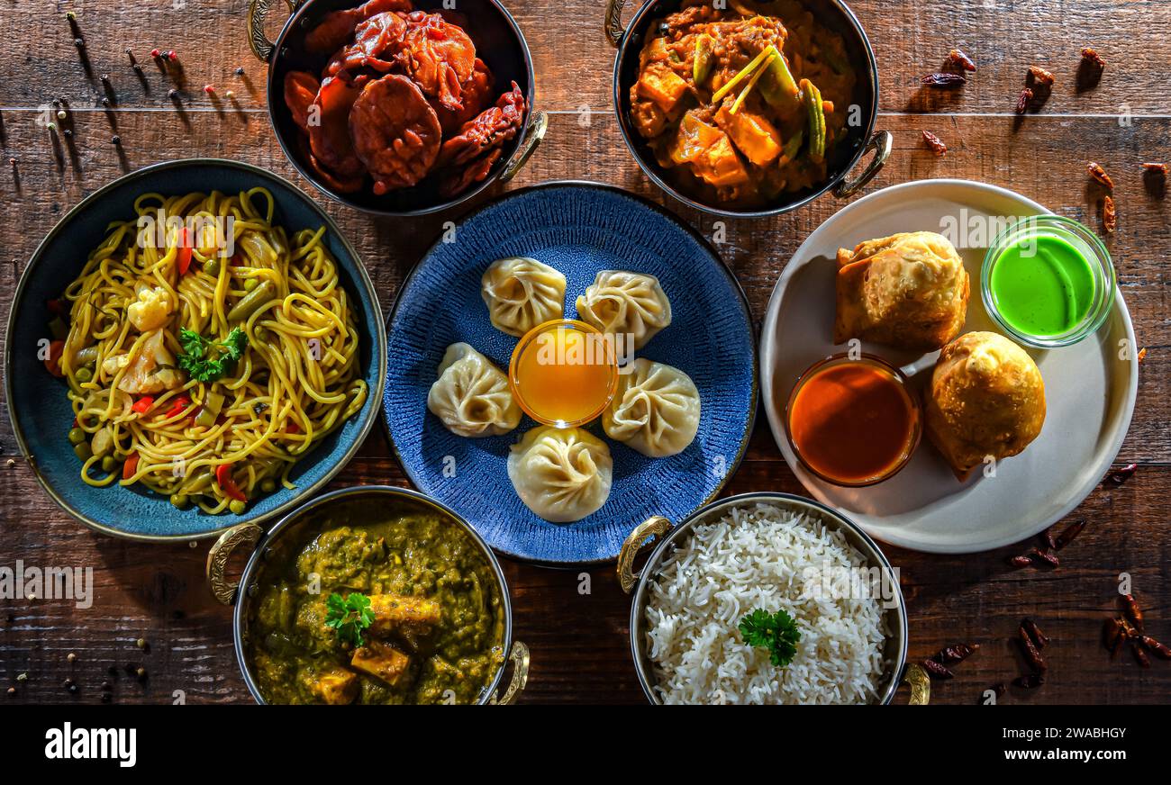 Composition with indian dishes: samosa, pakora, palak paneer, jalfrezi ...