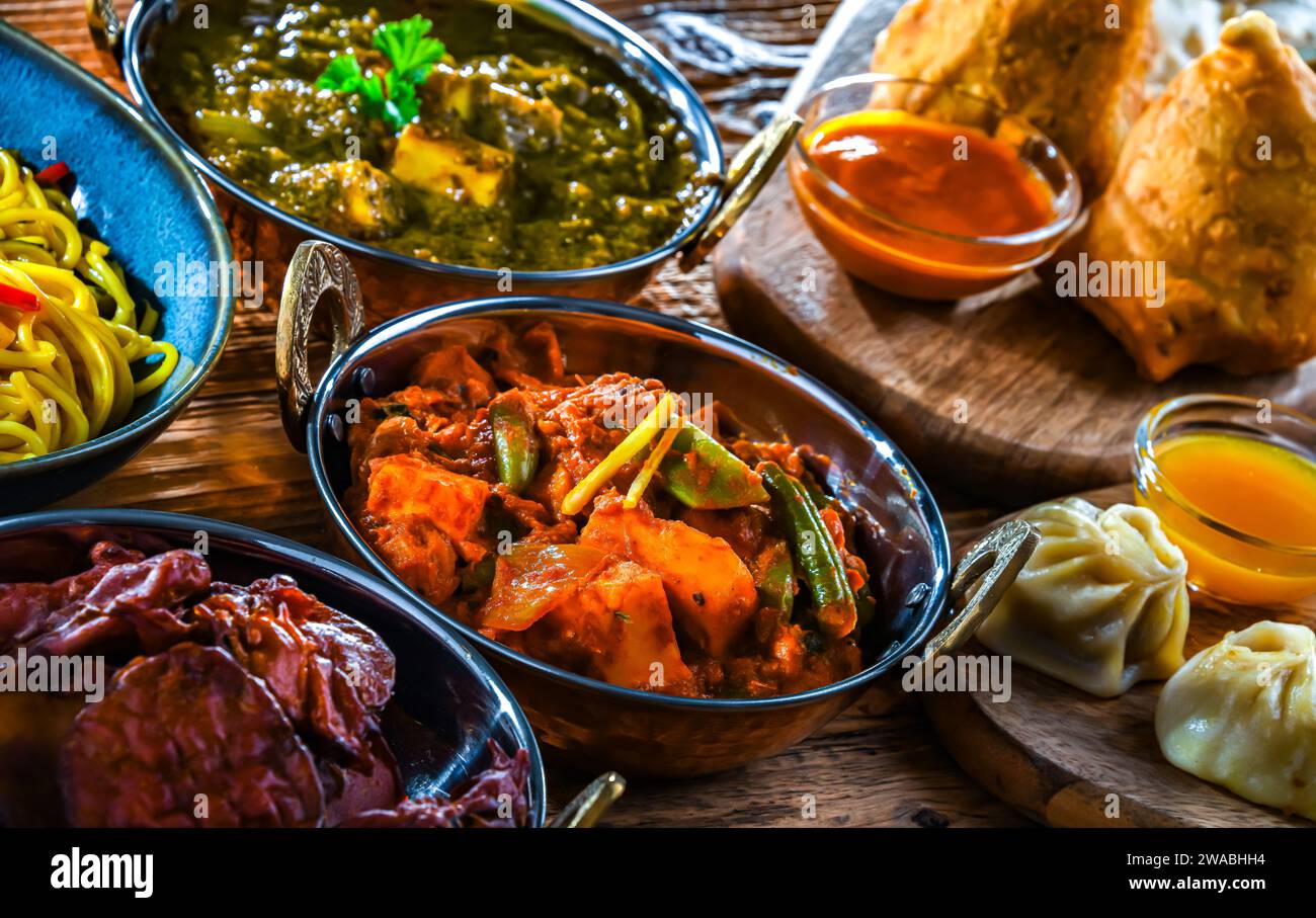 Composition with indian dishes: samosa, pakora, palak paneer, jalfrezi ...