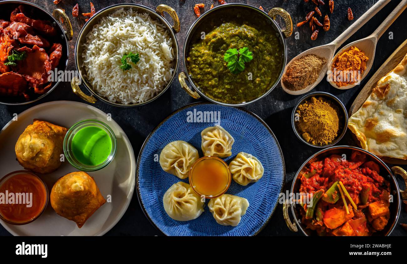 Composition with indian dishes: samosa, pakora, palak paneer, jalfrezi ...