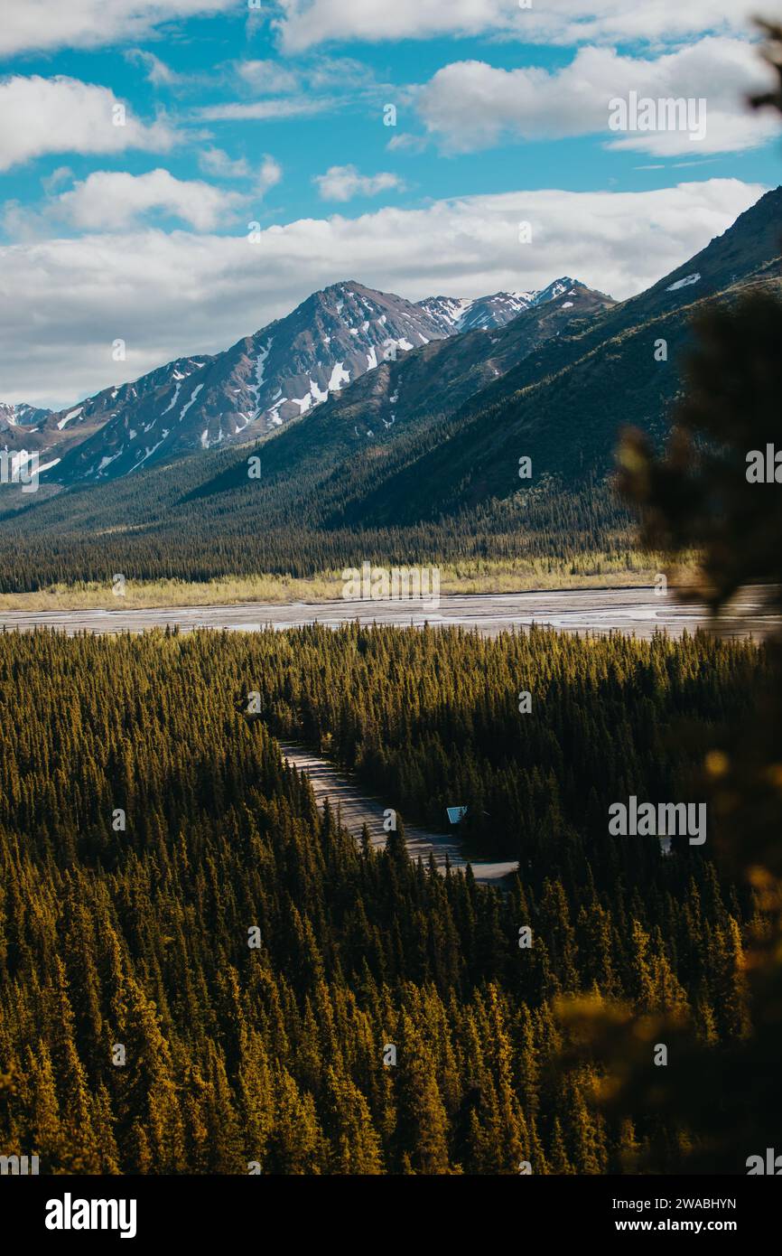 An aerial view of an Alaskan road with mountains in the background ...
