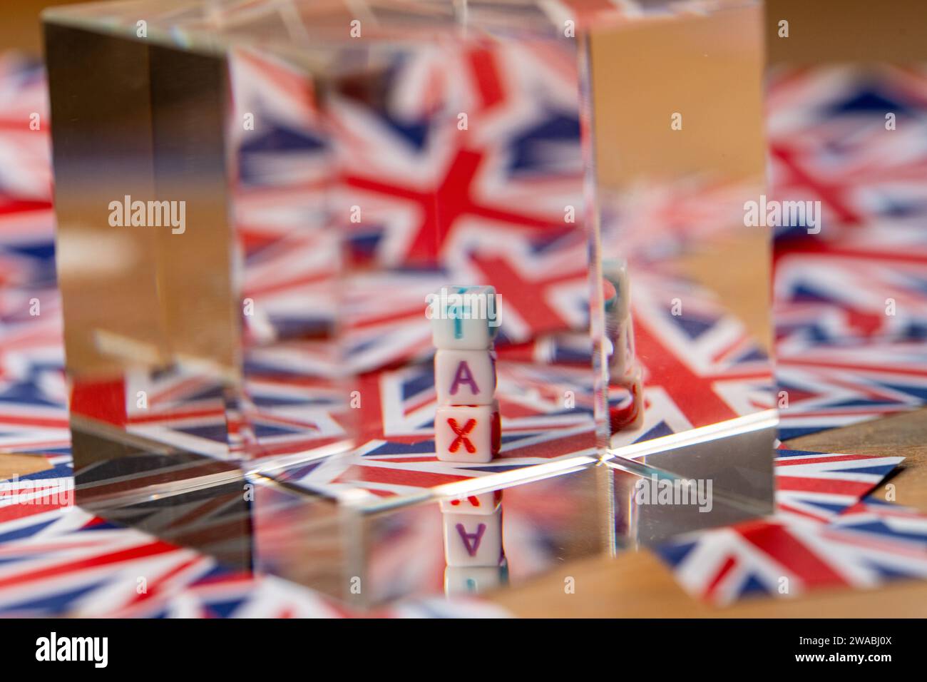 A crystal cube next to block letters spelling out TAX, future of Tax ...