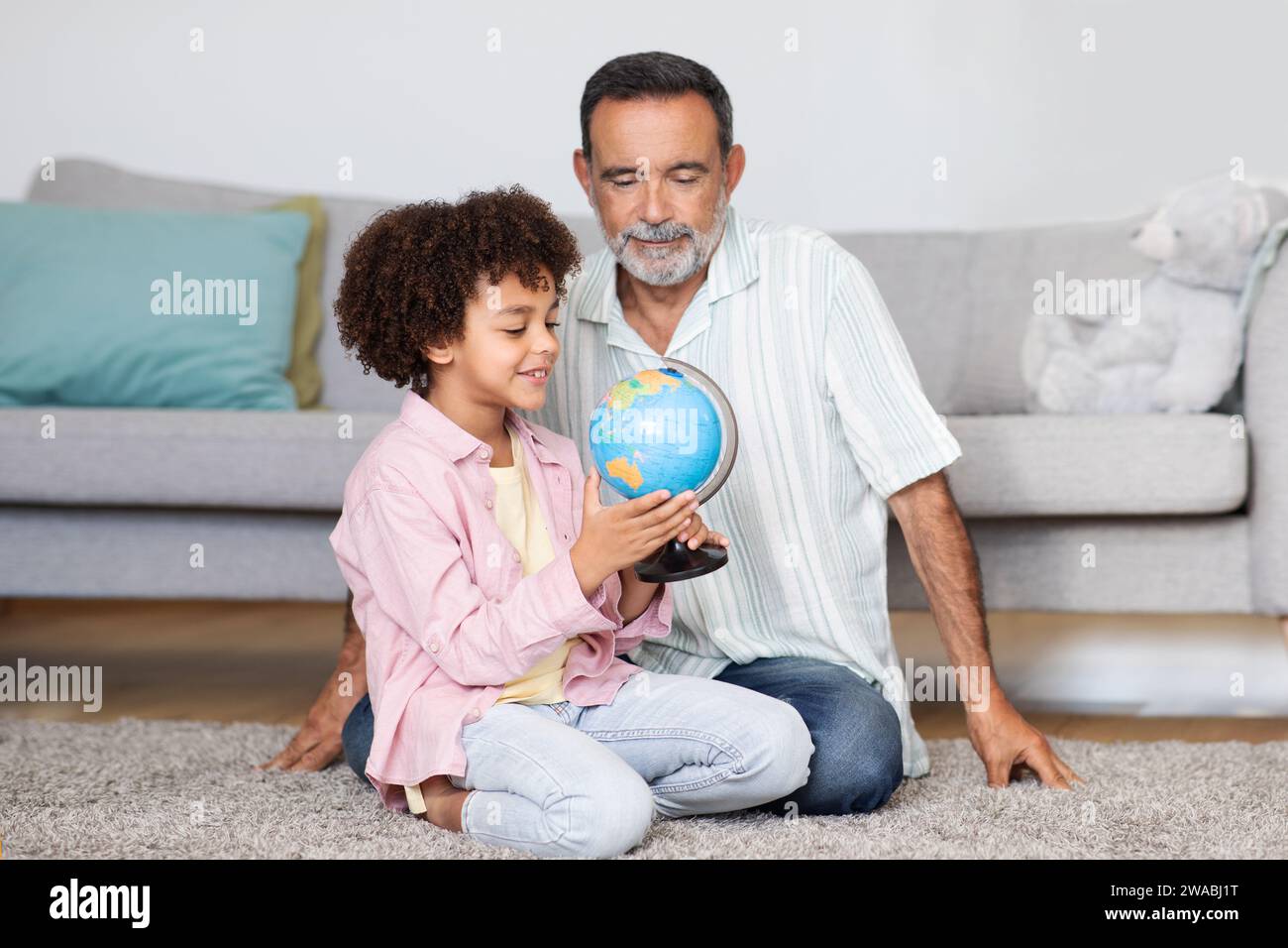 Mature Grandpa And His Little Grandson Holding World Globe Indoor Stock ...
