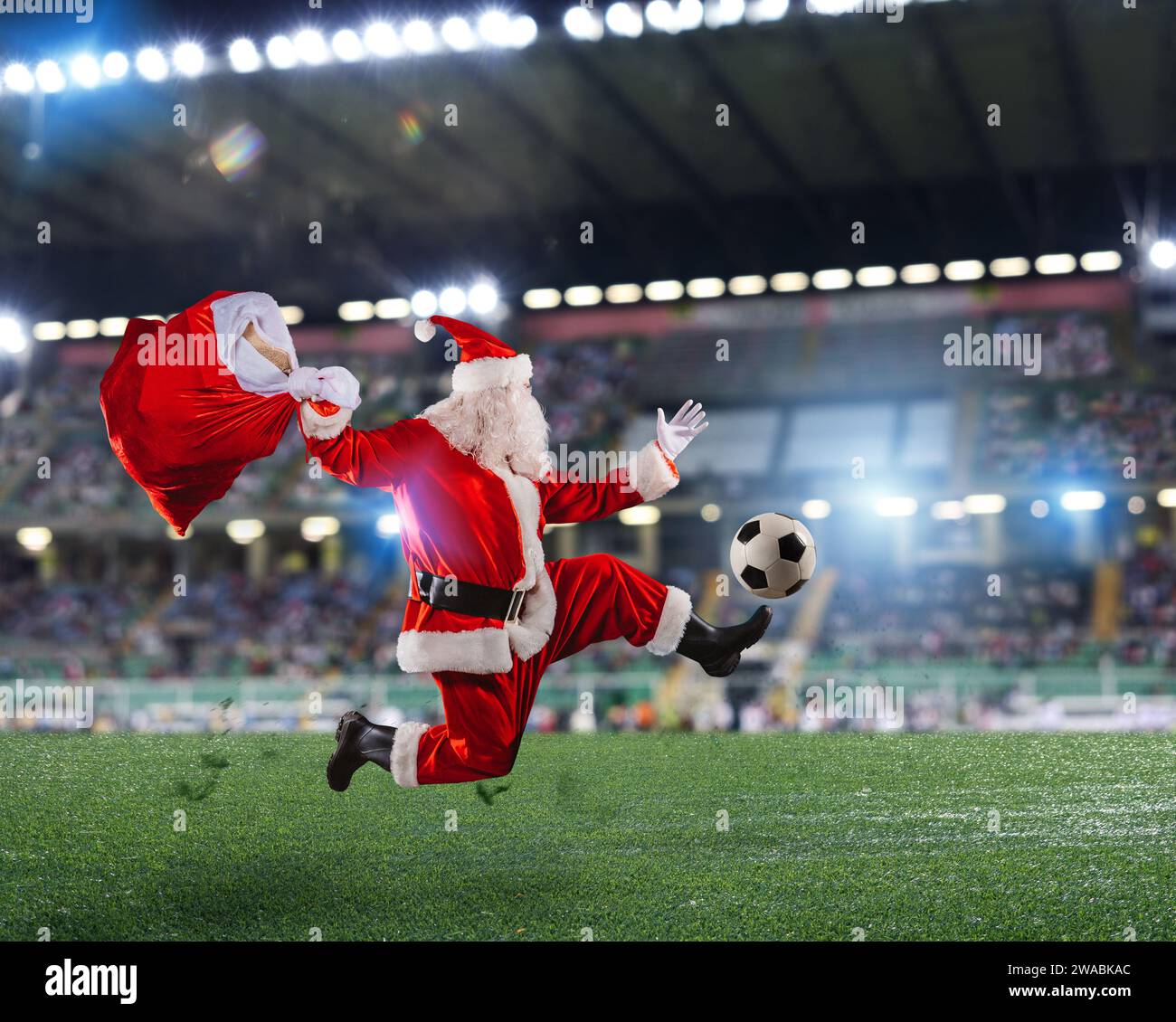 Santa claus runs fast with a soccerball in a football match Stock Photo ...