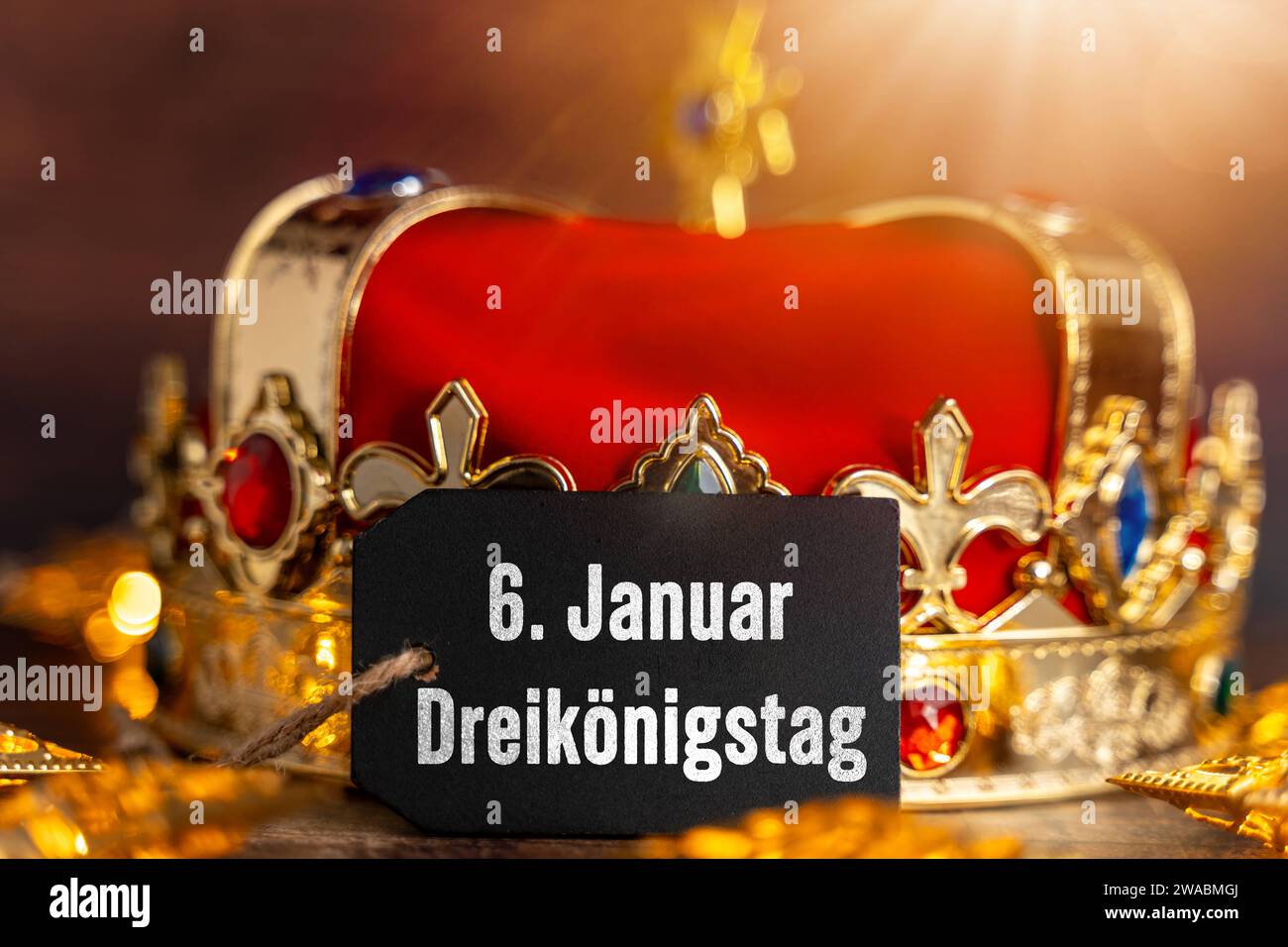 January 3, 2024: January 6 Epiphany lettering on a shield in front of a golden crown surrounded ...